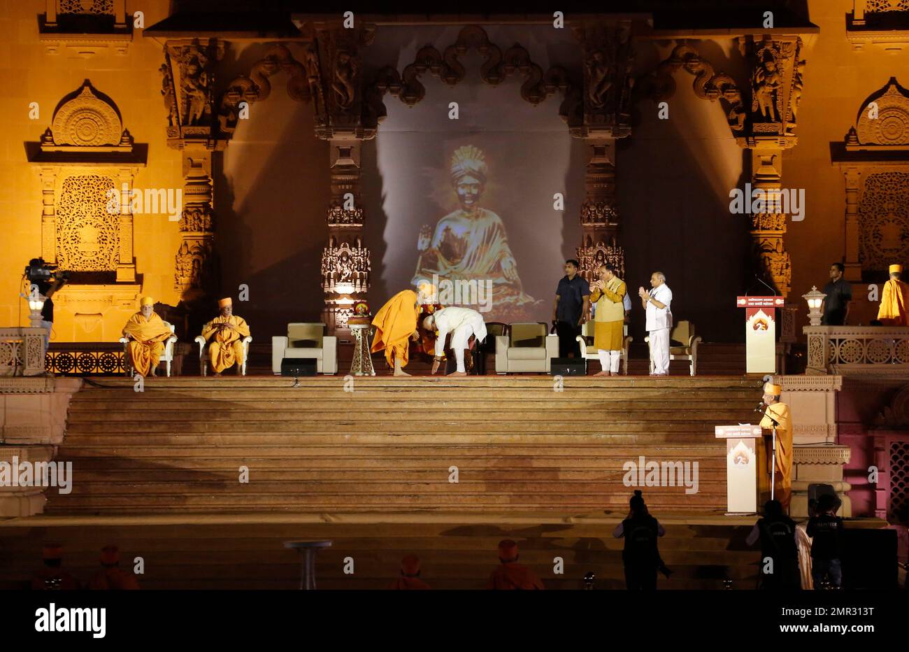 Indian Prime Minister Narendra Modi respectfully touches the feet of ...