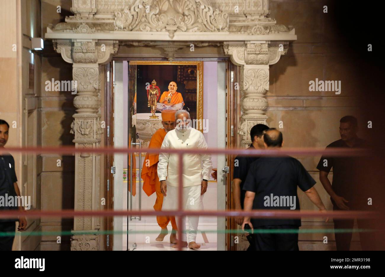 Indian Prime Minister Narendra Modi walks followed by head saint of The ...