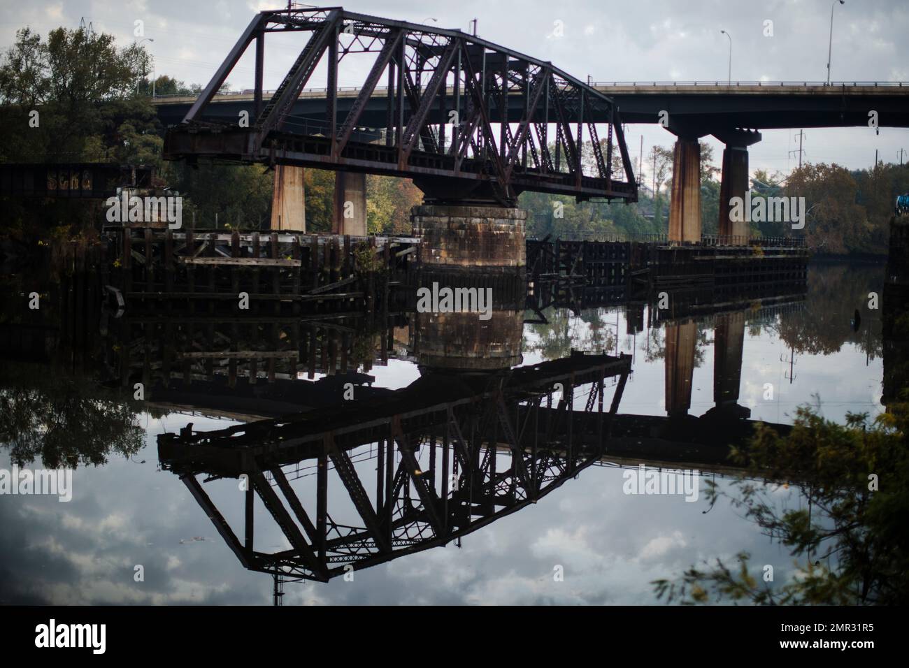 A swing bridge is reflected in the Schuylkill River in Philadelphia ...