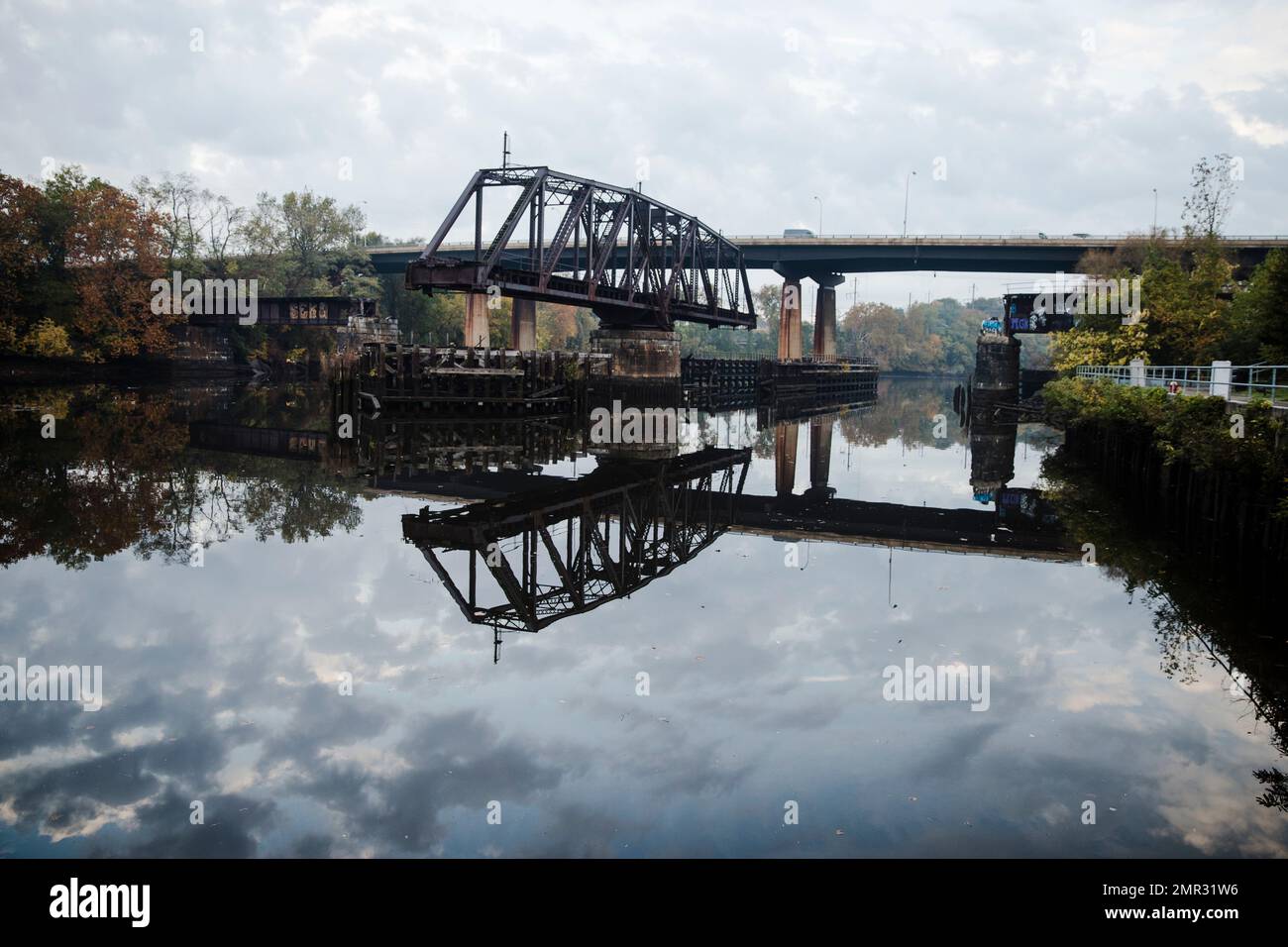 A swing bridge is reflected in the Schuylkill River in Philadelphia ...