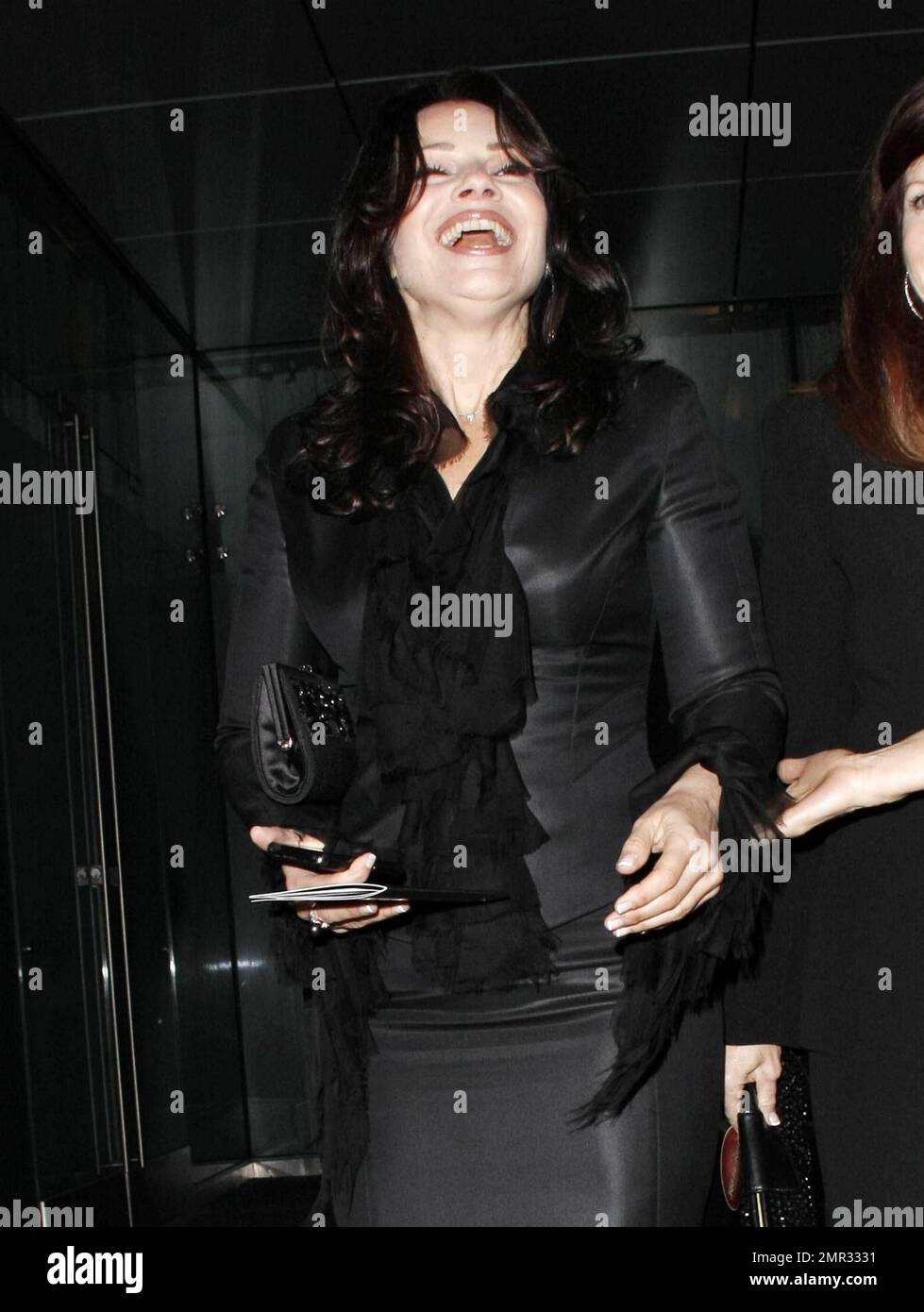 In a nice black ruffle-detailed skirt suit Fran Drescher is all smiles ...