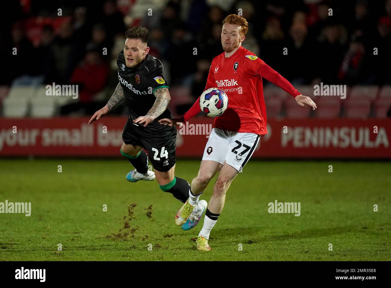 Walsall’s Joseph Low (left) and Salford City’s Callum Morton in action ...