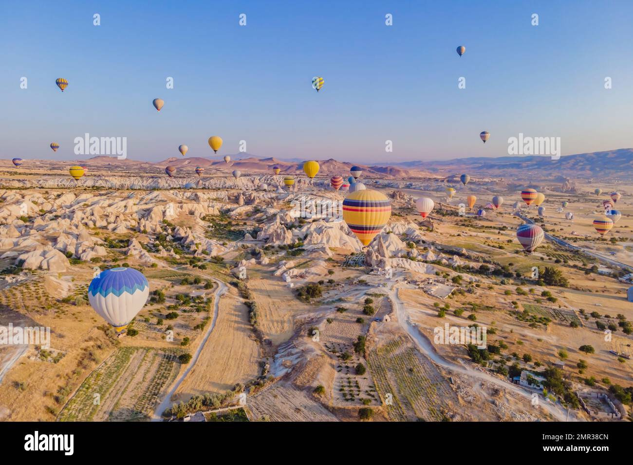 Colorful hot air balloons flying over at fairy chimneys valley in ...