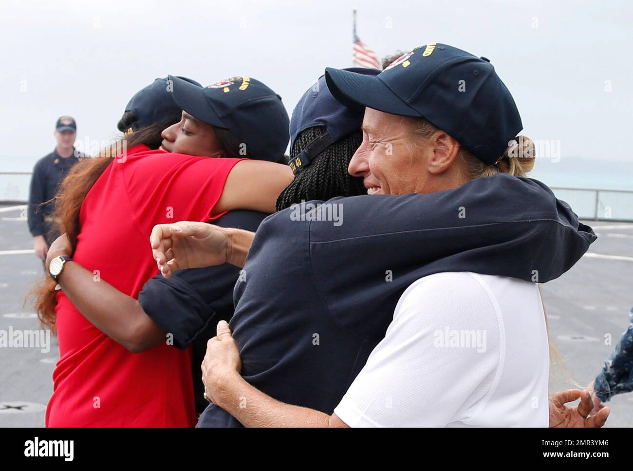 Jennifer Appel, right, and Tasha Fuiava, left, hug with crew members of ...