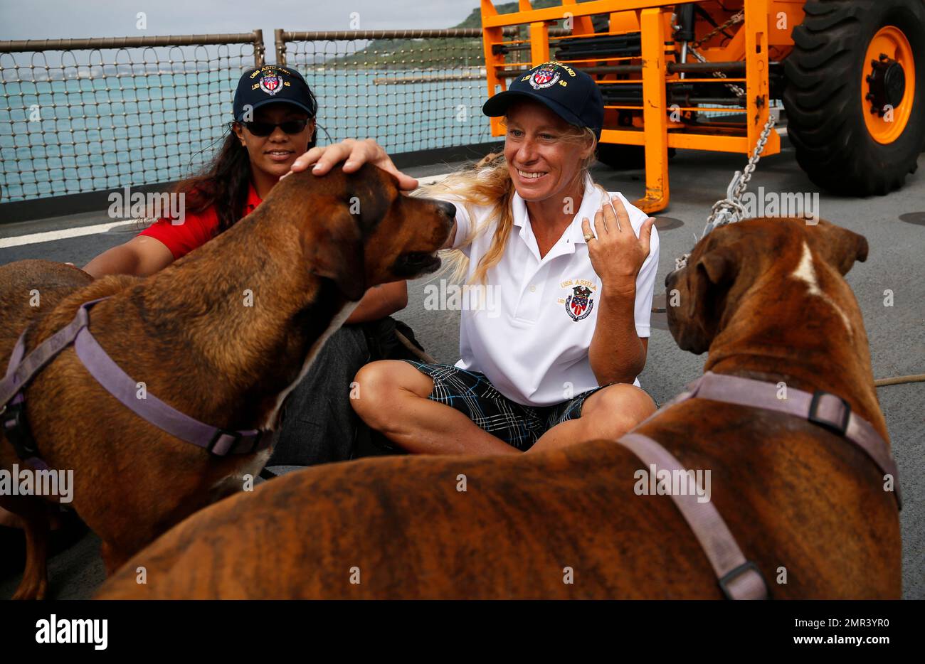 Jennifer Appel, right, and Tasha Fuiava sit with their dogs on the deck ...
