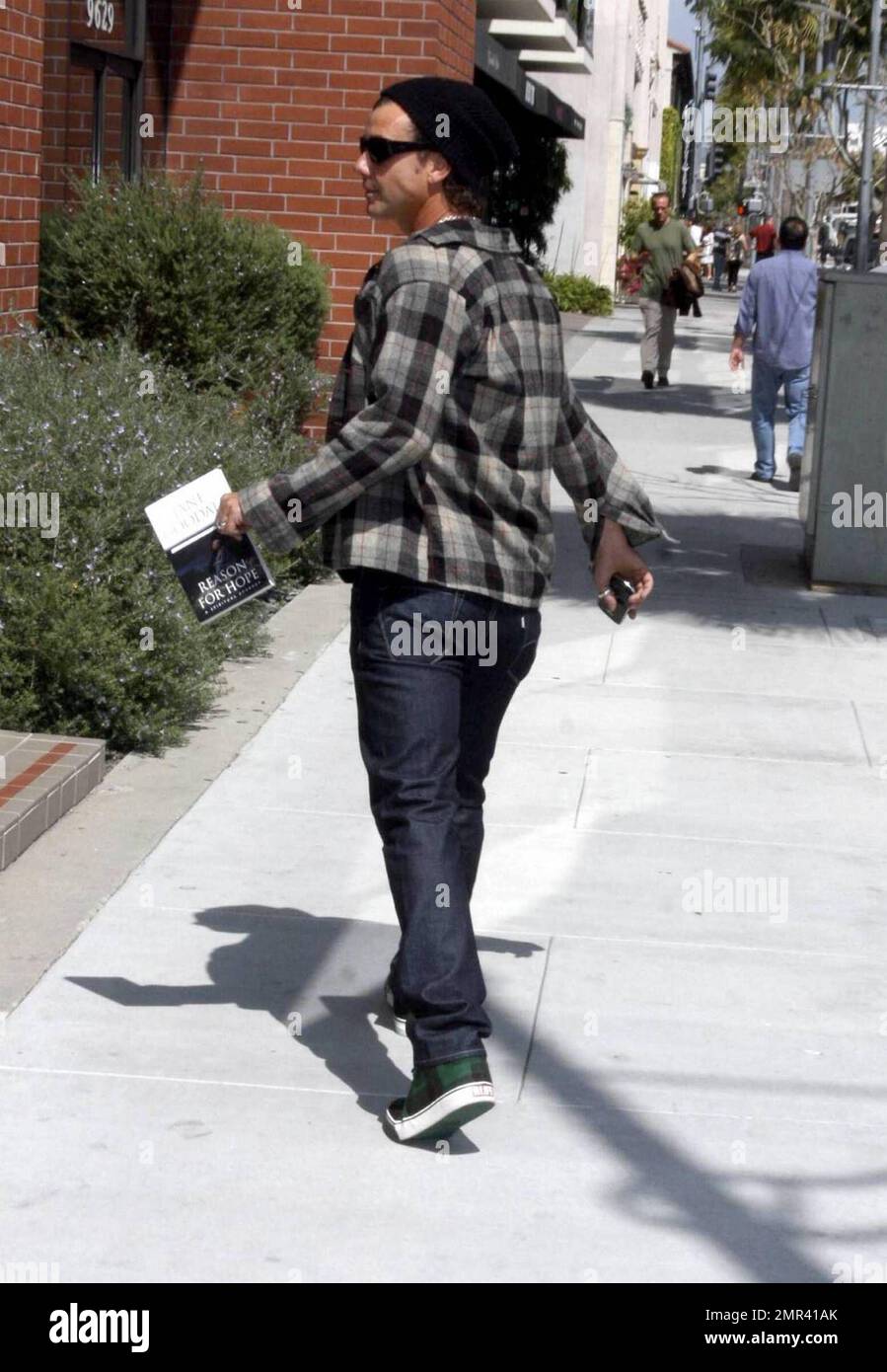 Gavin Rossdale takes a walk carrying along the book he's reading ...