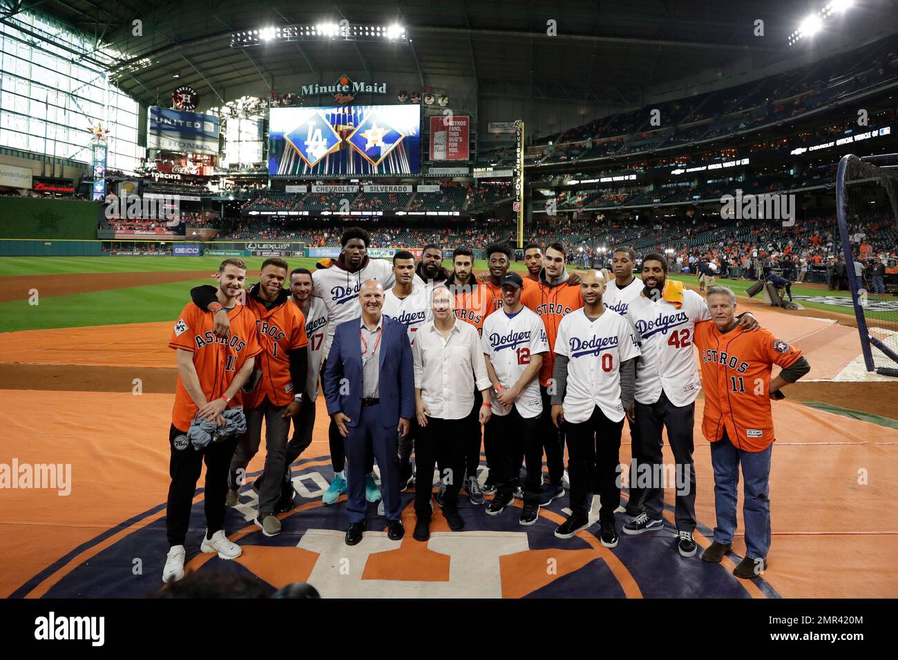 Members of the Philadelphia 76ers pose for a picture on the field ...