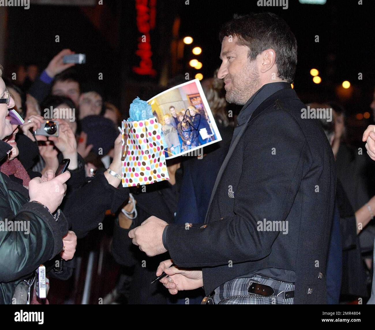 Scottish actor Gerard Butler signs autographs in his traditional ...