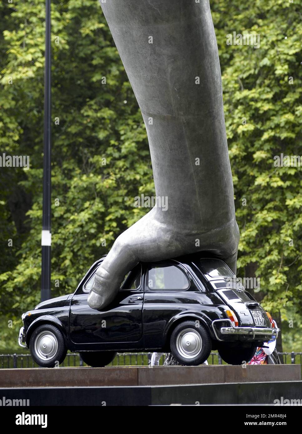 This statue of a giant hand picking up a car is on display in Hyde Park ...