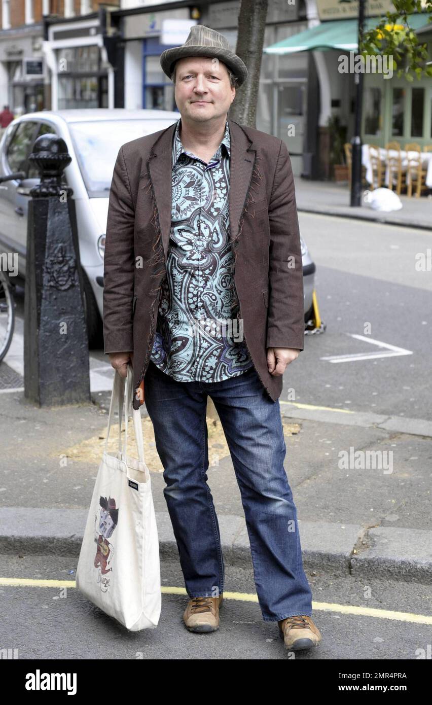 Guitarist and singer for Squeeze, Glenn Tillbrook carries a shopping ...