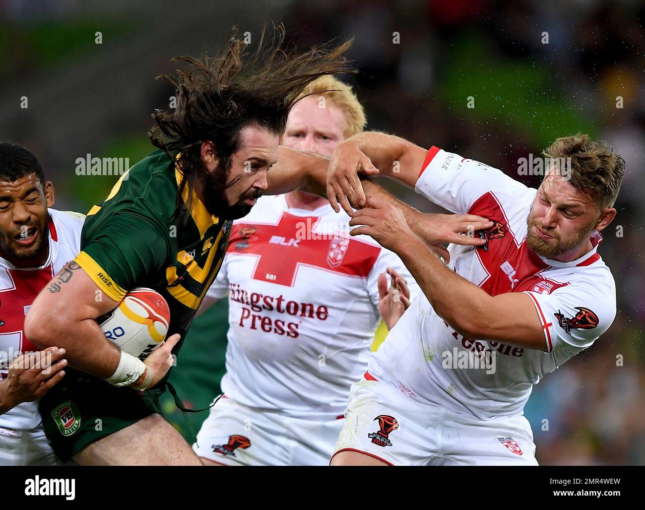 Australia's Aaron Woods, left, fends off England's Elliott Whitehead ...