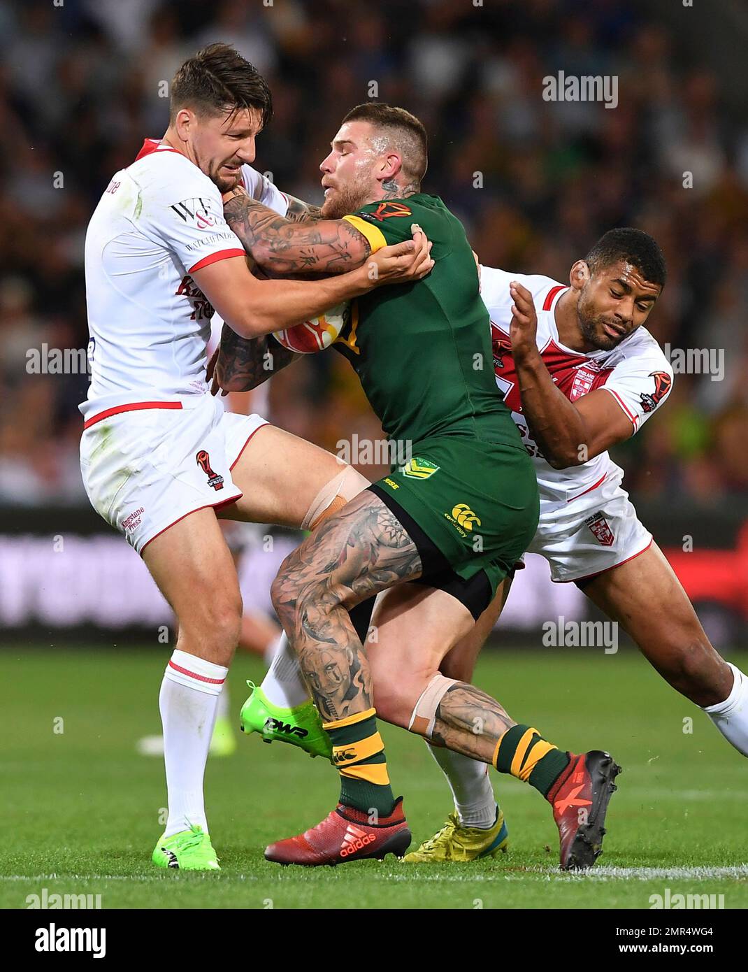 England's Gareth Widdop, left, and Kallum Watkins, right, tackle ...