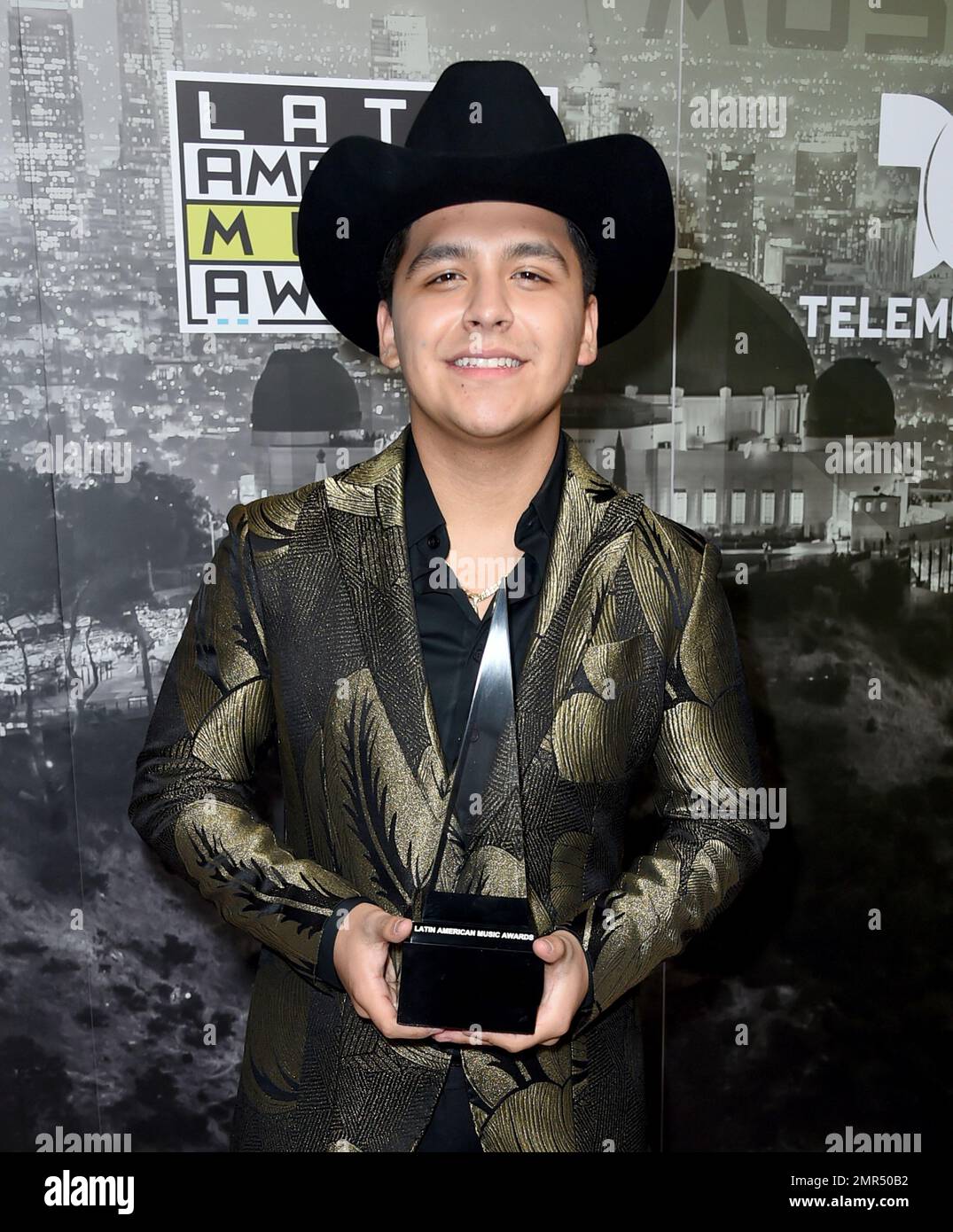 Christian Nodal poses backstage with the award for favorite song ...