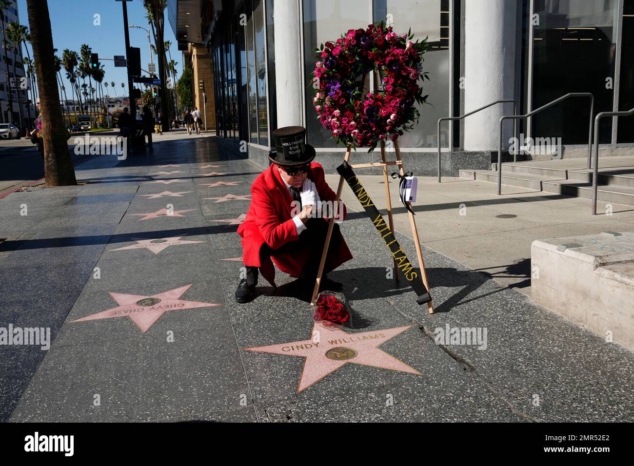 Former Beverly Hills ambassador Gregg Donovan kneels in front of ...