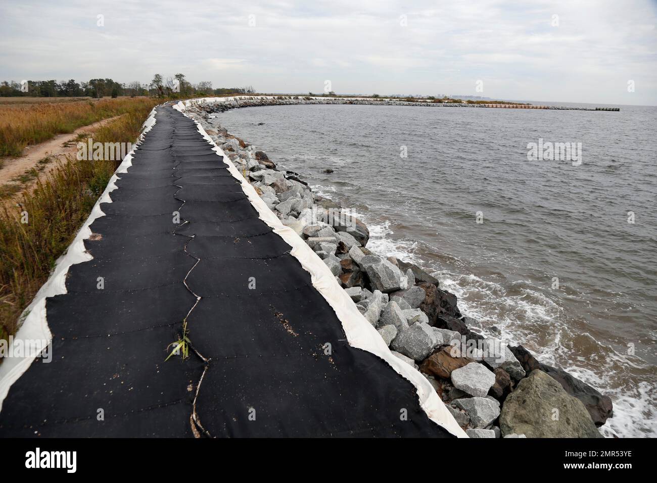 Sand bags raise a berm on the beach in the Oakwood Beach section in the ...
