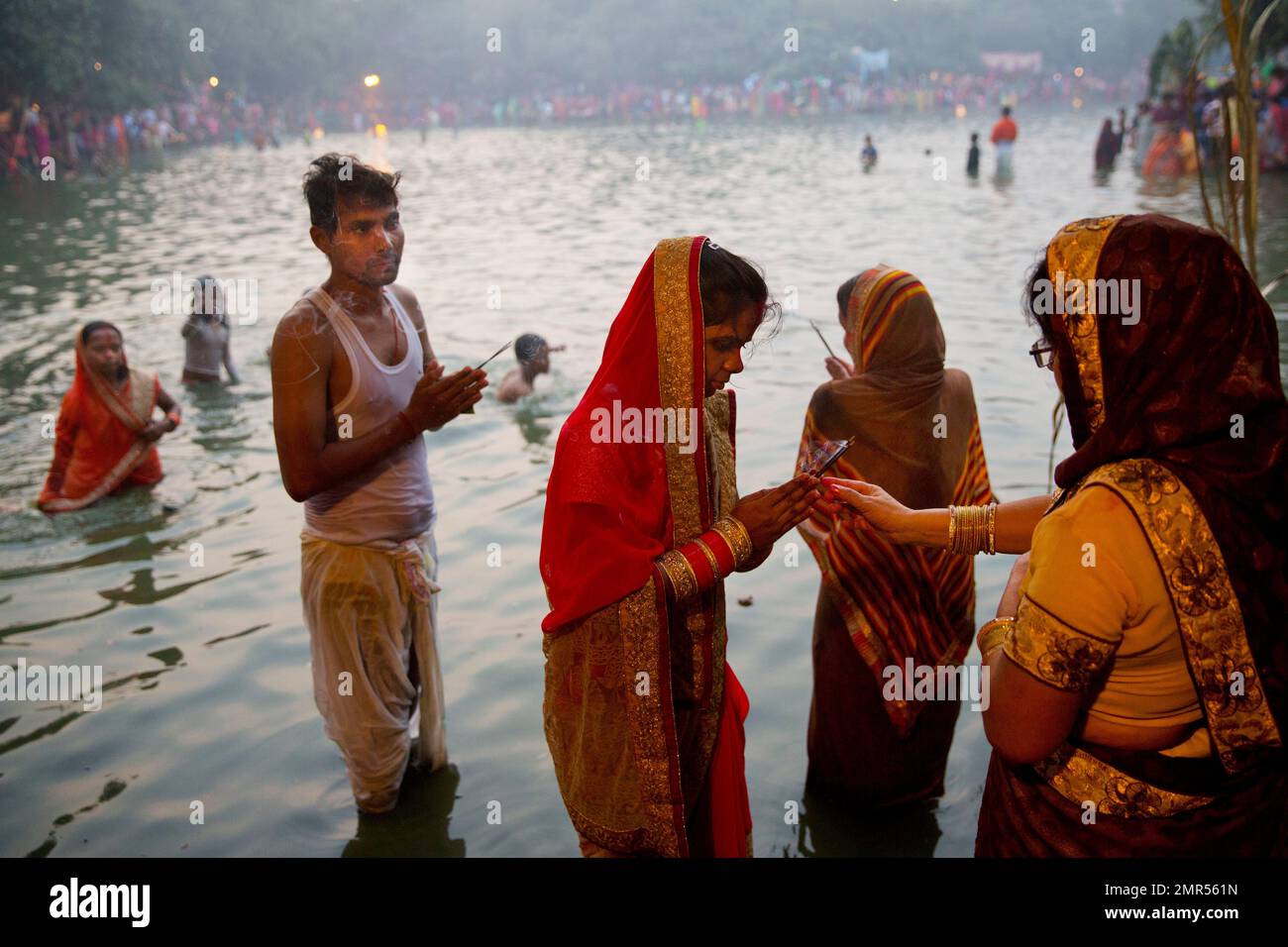 Hindu devotees perform rituals in a pond during Chhath Puja festival in ...
