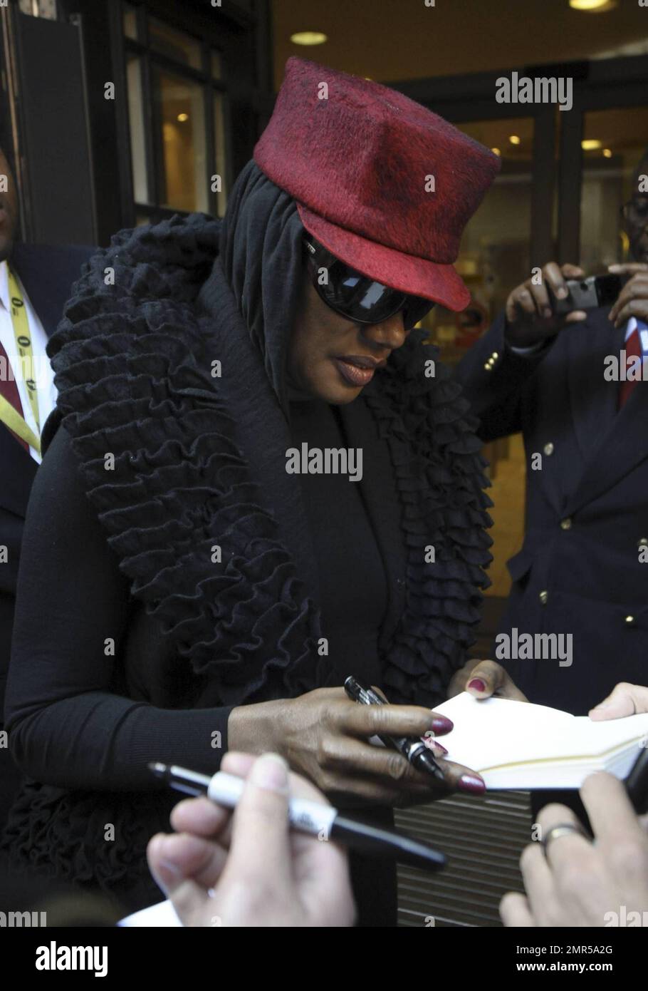 Grace Jones signs autographs for her loyal fans outside the BBC. As ...