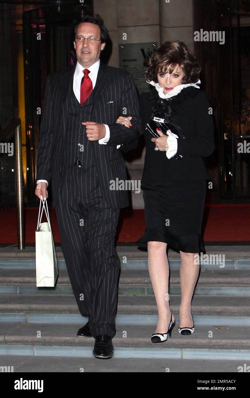 Joan Collins and Percy Gibson leave the Victoria & Albert Museum after ...