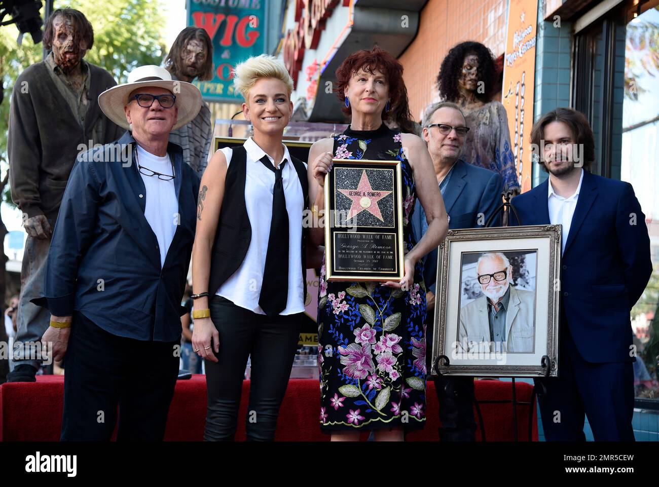 Suzanne Desrocher, center, the widow of the late director George A ...