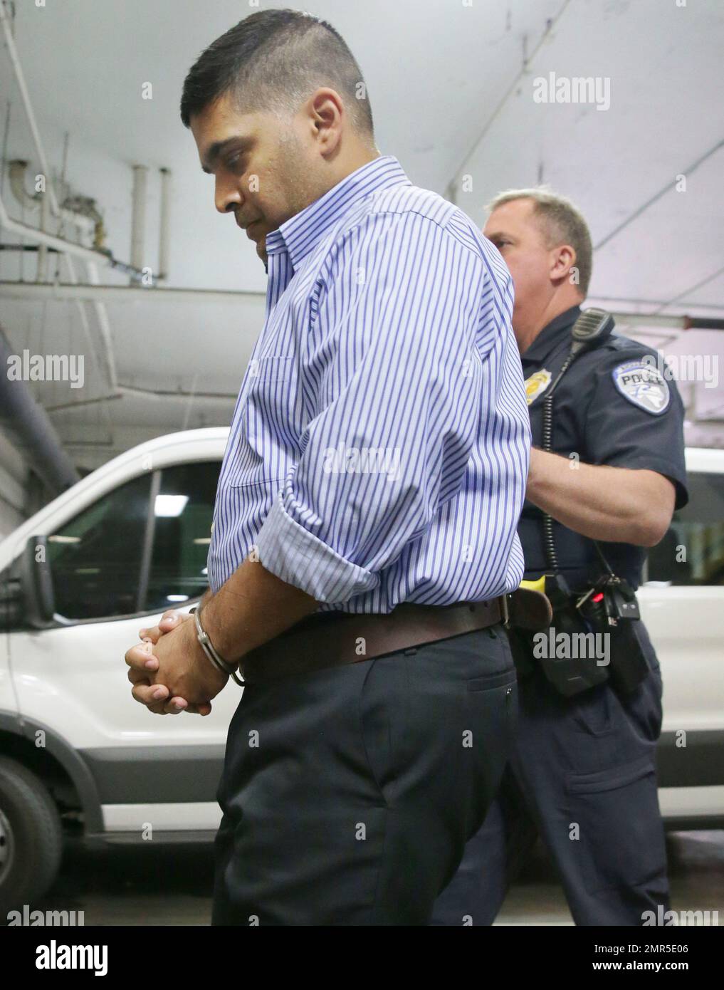 Wesley Mathews is escorted by police during his transfer to Dallas ...