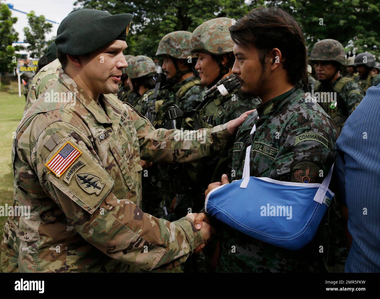 A member of the U.S. Army who trains Philippine troopers welcomes a ...