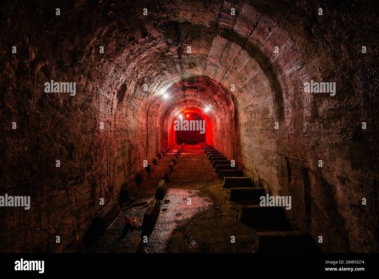 Vaulted tunnel with concrete walls in old abandoned bunker, mine ...