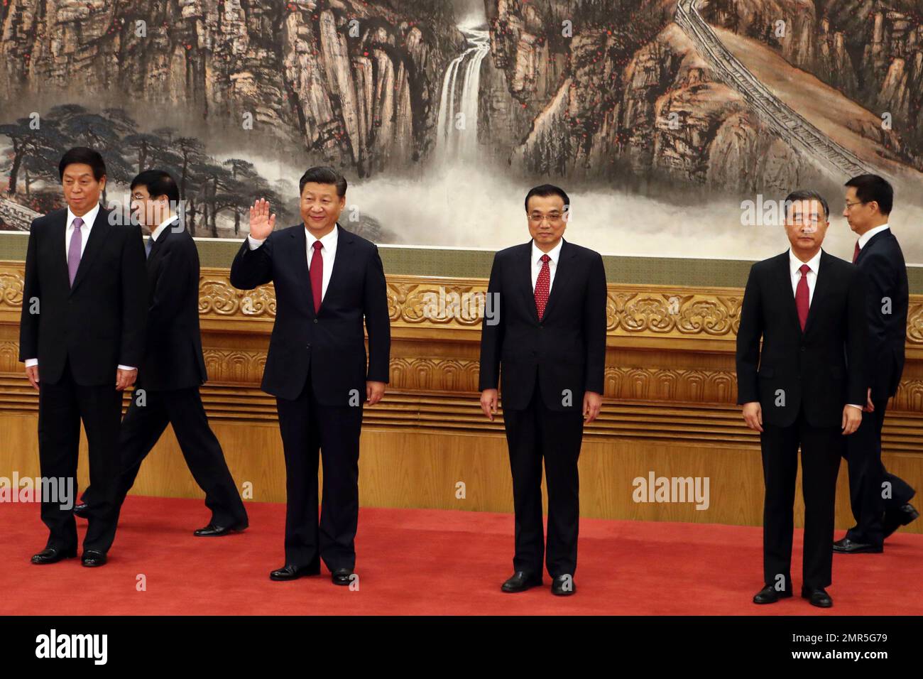 Chinese President Xi Jinping, third from left, waves as he walks in ...