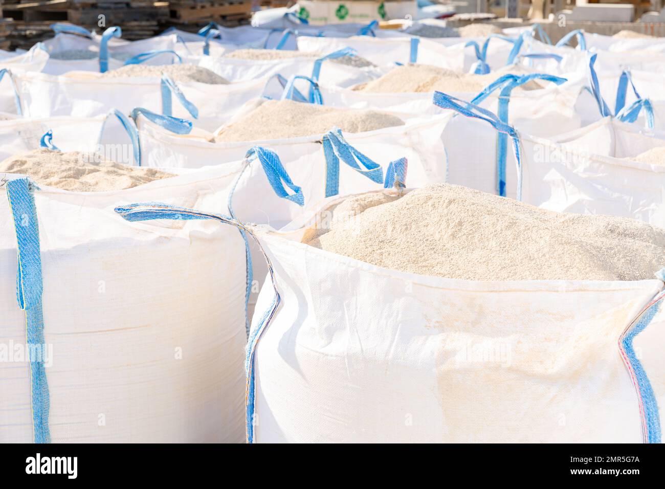 Bags of building mix at hardware store warehouse Stock Photo - Alamy