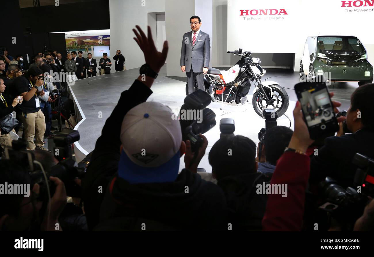 Honda Motor Co. President Takahiro Hachigo poses for a photo with a Honda Riding Assist-e ...