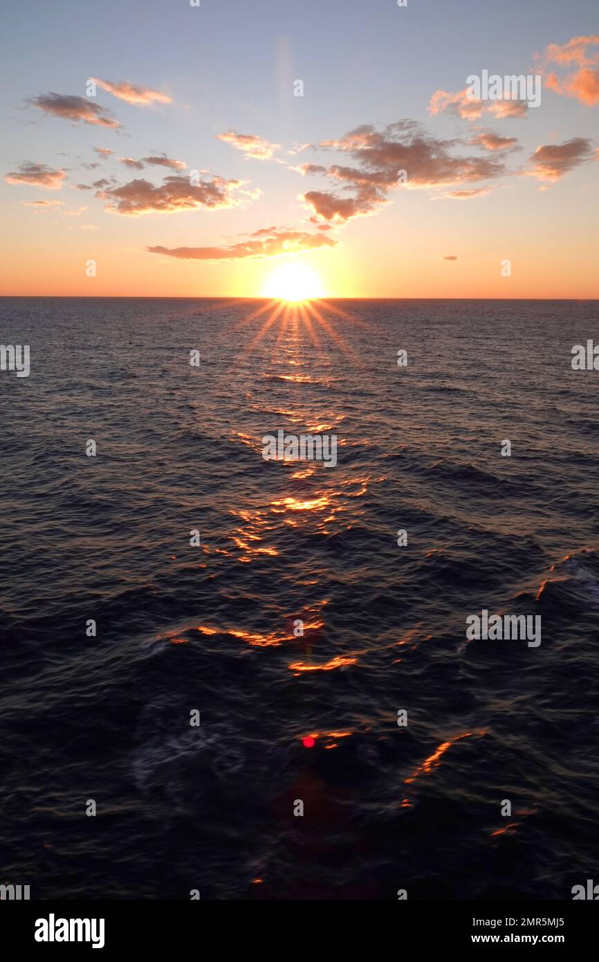 Sunset over the ocean Stock Photo - Alamy