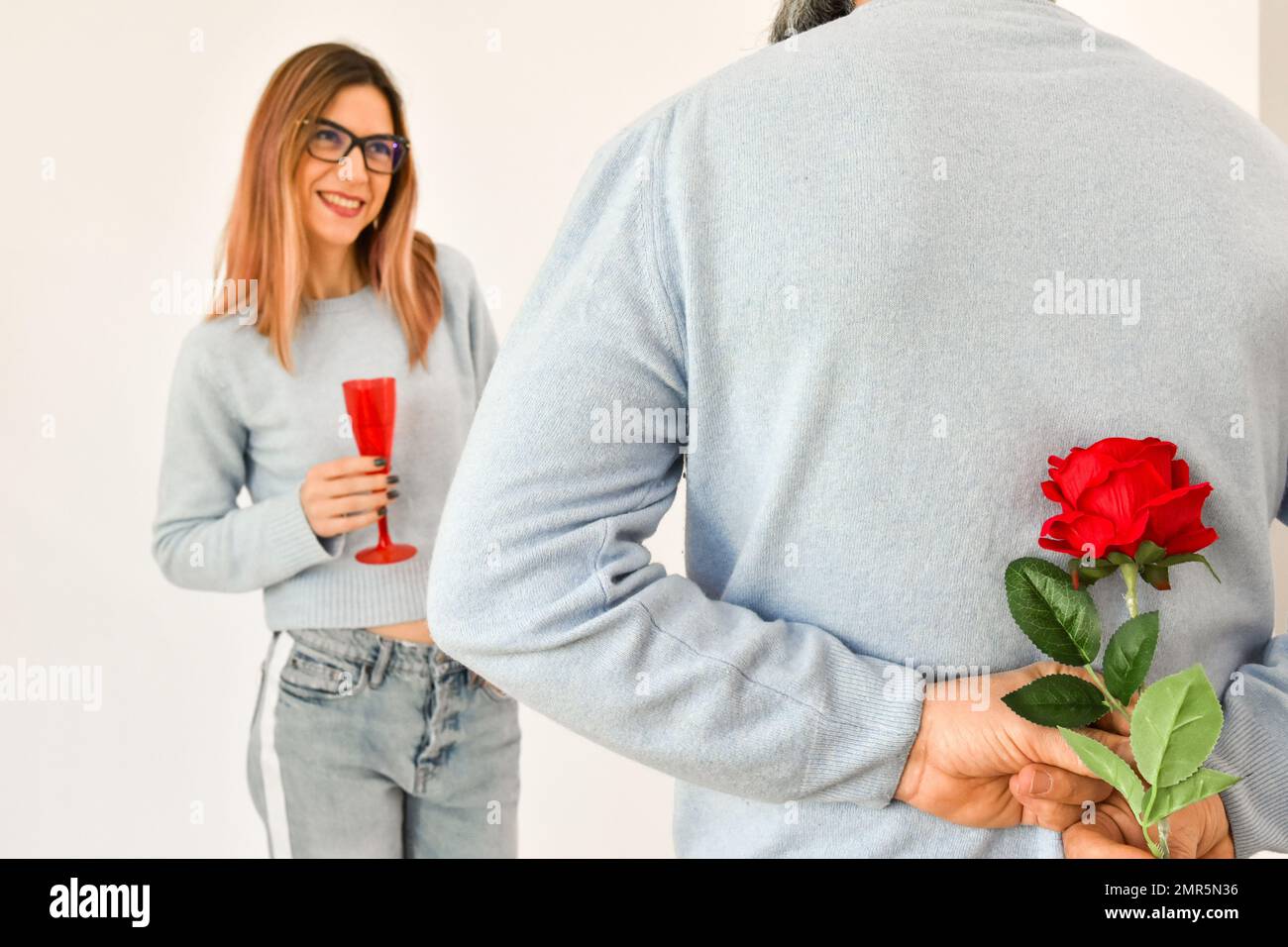 Husband hiding flower behind back hi-res stock photography and images ...