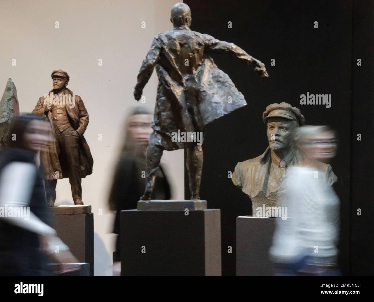 Visitors walk among Vladimir Lenin sculptures at the exhibition 'The ...
