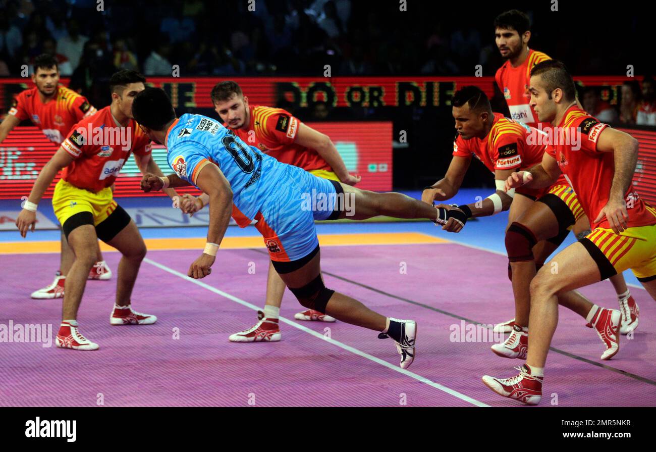 Players of Gujarat Fortune Giants pin down Deepak Narwal, in blue jersey, of Bengal Warriors ...