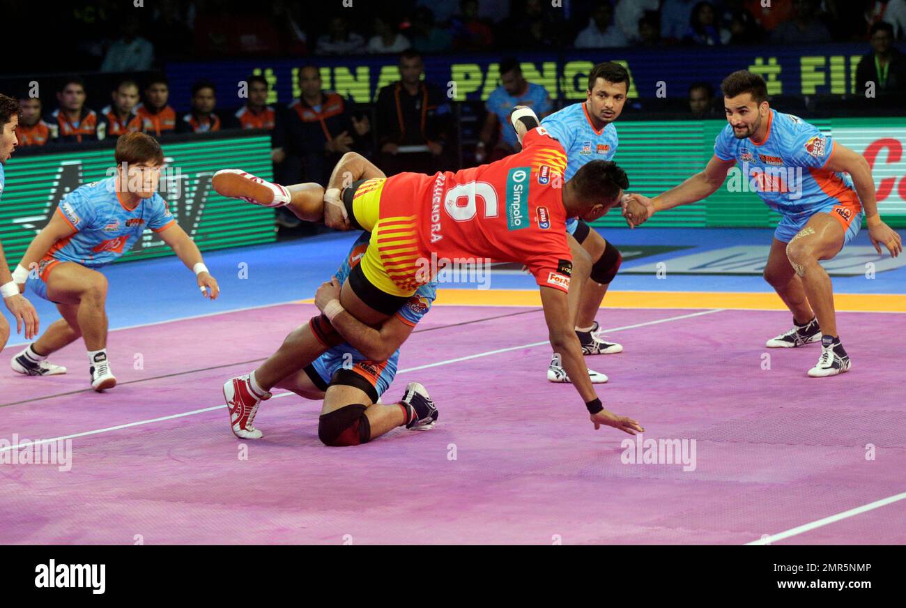 Players of Bengal Warriors pin down Mahendra Ganesh Rajput, in orange ...