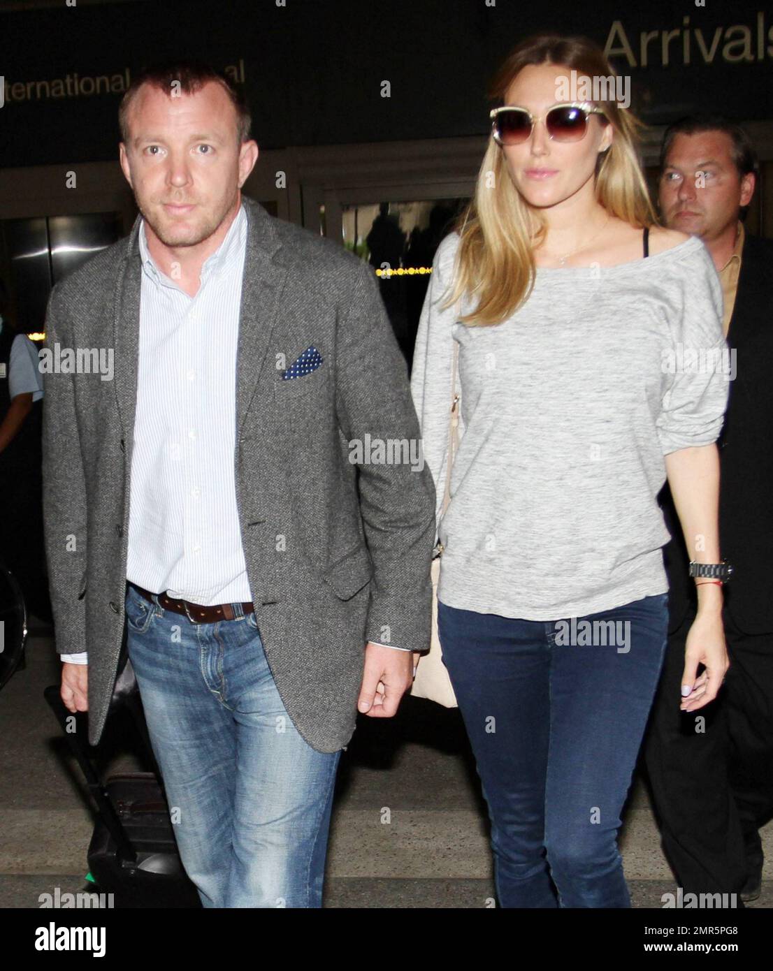Director Guy Ritchie with his pregnant girlfriend Jacqui Ainsley ...