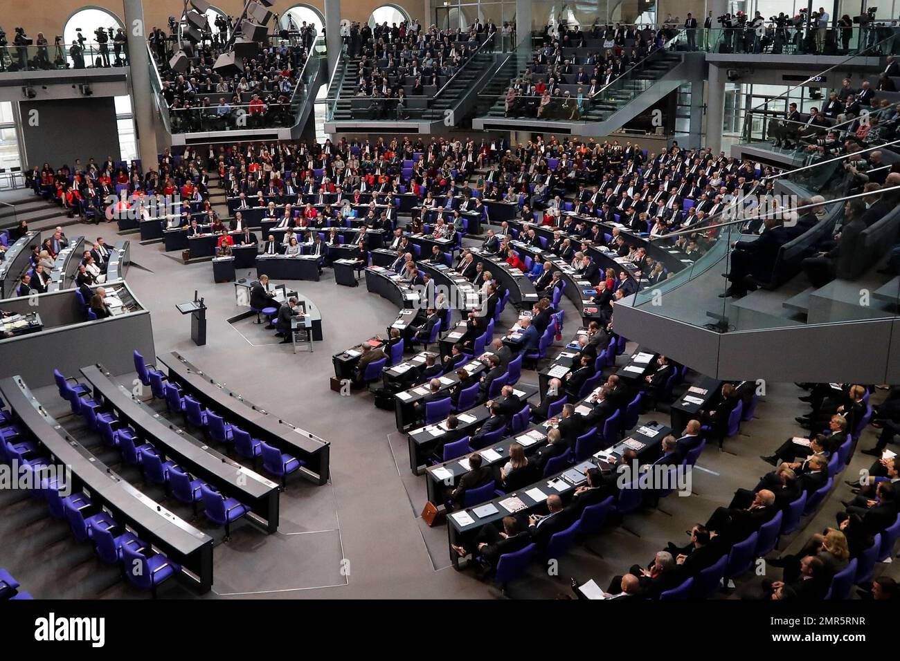 German lawmakers attend the first meeting of the German parliament ...