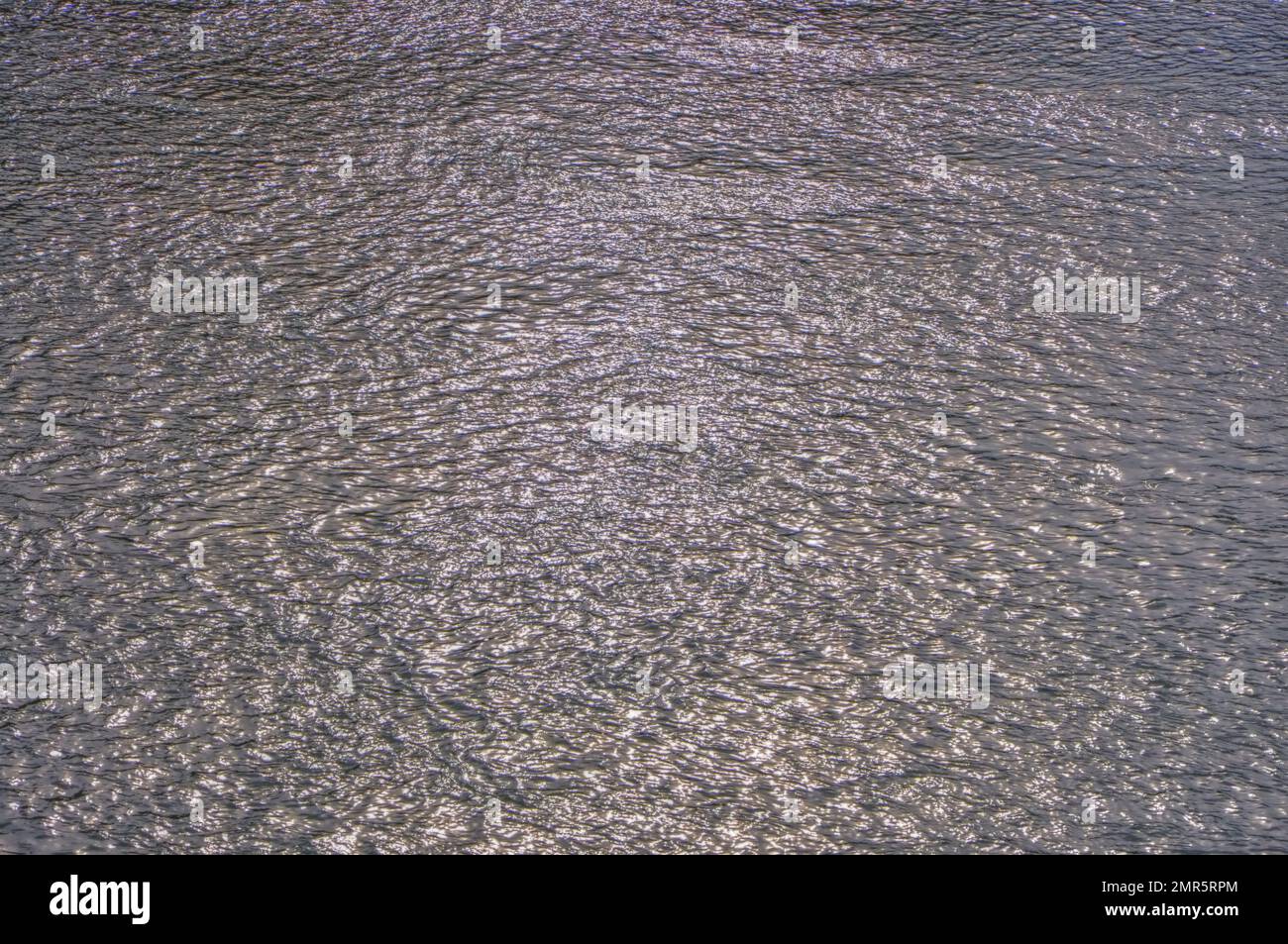 Abstract metallic color of water surface.Sea surface covered with tiny ...