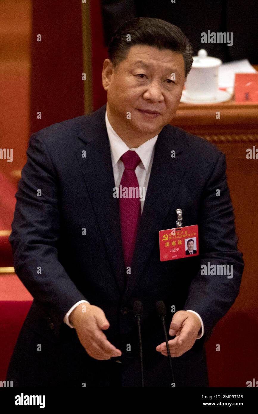 Chinese President Xi Jinping adjust the microphone during the closing ...