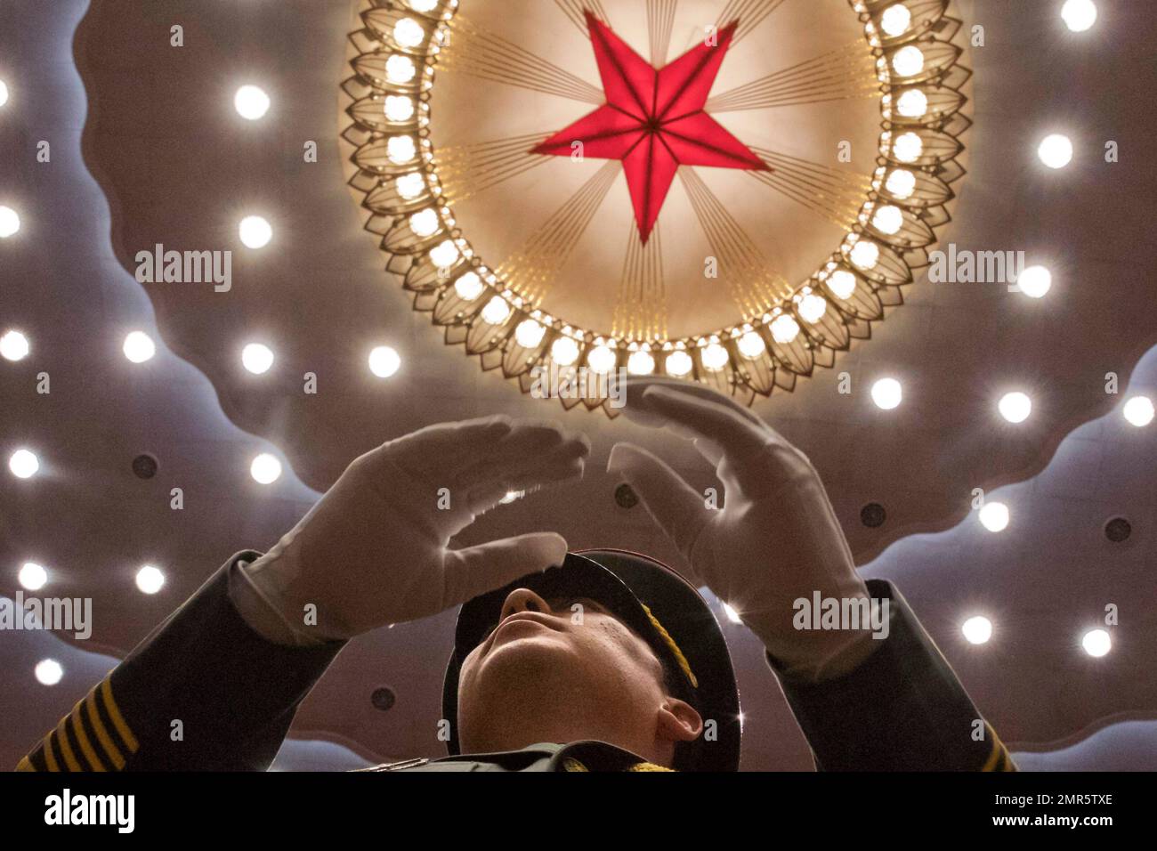 A military band conductor leads the band during the closing ceremony ...