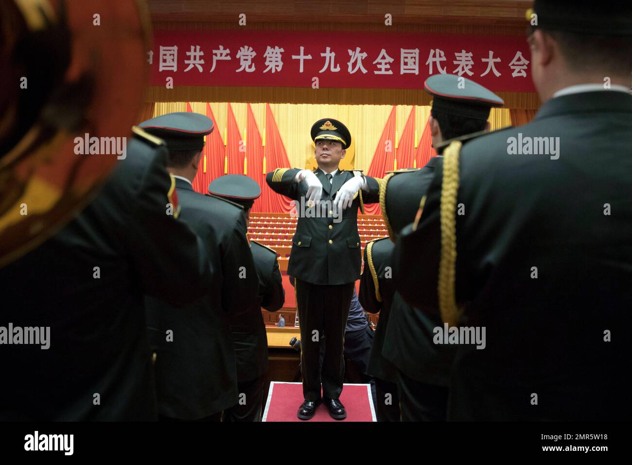 A military band conductor leads the band during the closing ceremony ...