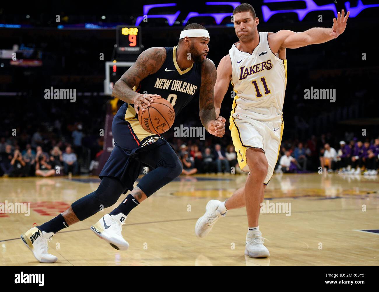 New Orleans Pelicans center DeMarcus Cousins, left, drives the ball as ...