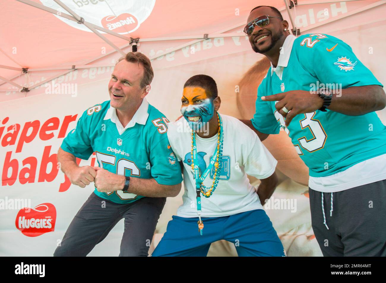 IMAGE DISTRIBUTED FOR HUGGIES - Fan poses with former Miami Dolphins ...