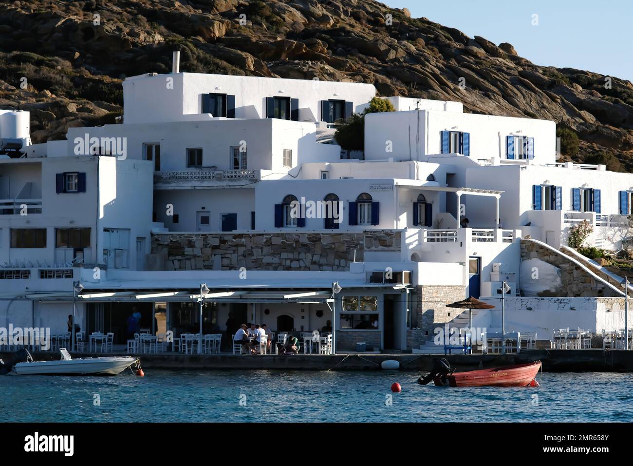 Ios, Greece - June 3 , 2021 : View of a whitewashed hotel and a seafood ...