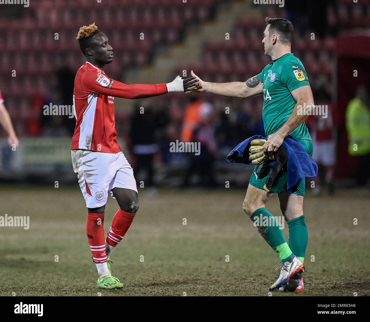 Daniel Agyei #11 of Crewe Alexandra shake hands with Ben Hinchliffe #1 ...