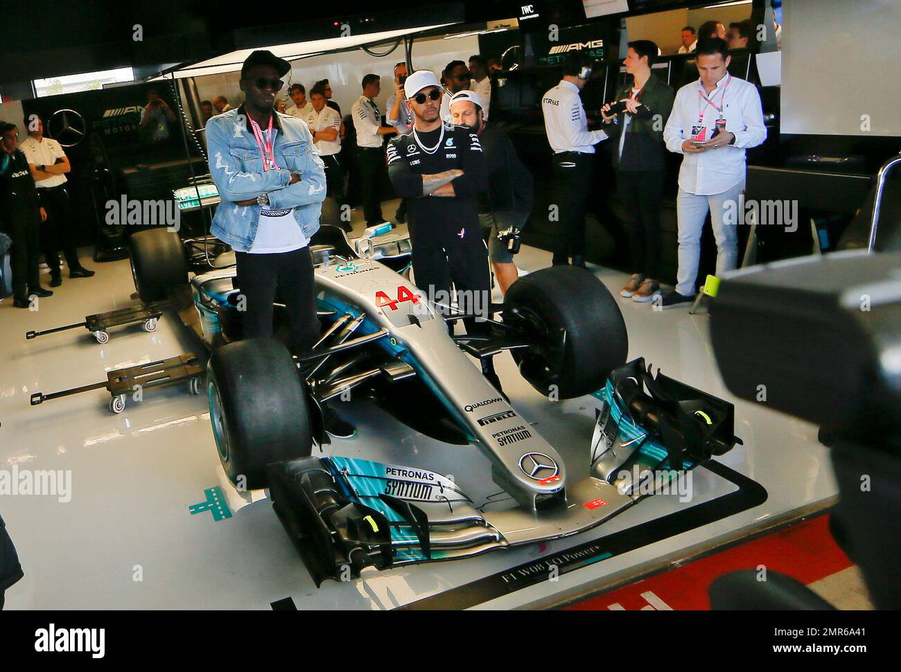 Sprinter Usain Bolt, left, poses with Mercedes driver Lewis Hamilton ...