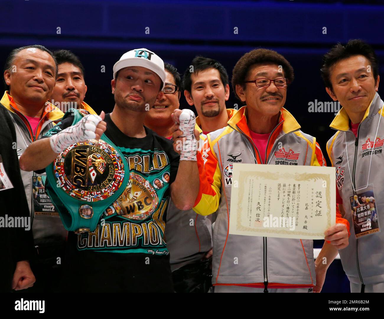 Japanese champion Daigo Higa poses for a photo with his gym's chief Yoko Gushiken, second from ...