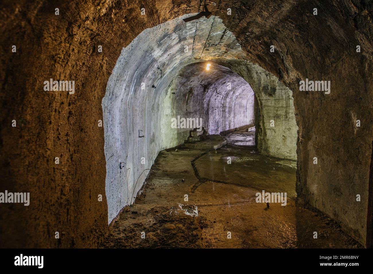 Vaulted tunnel with concrete walls in old abandoned bunker, mine ...