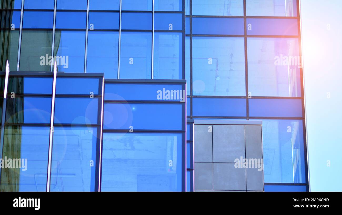 Abstract closeup of the glass-clad facade of a modern building covered ...
