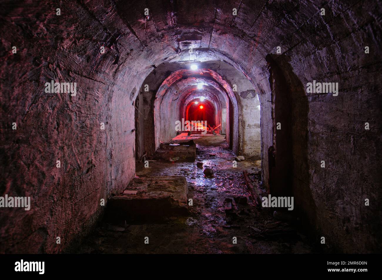 Vaulted tunnel with concrete walls in old abandoned bunker, mine ...