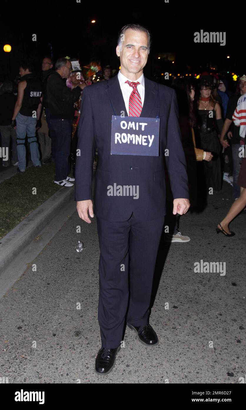 Participant dressed in a suit with an "Omit Romney" sign around his ...